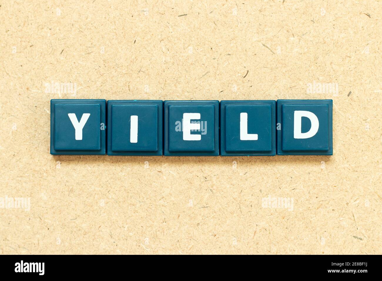 Tile alphabet letter in word yield on wood background Stock Photo - Alamy