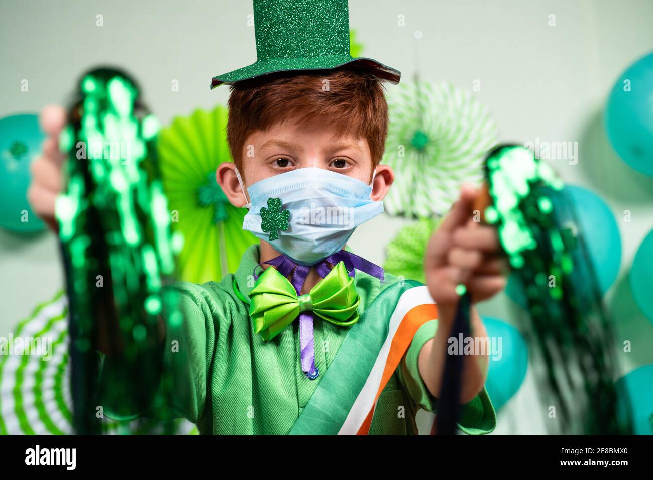 young kid with medical face mask dancing by holding pom pom on ...