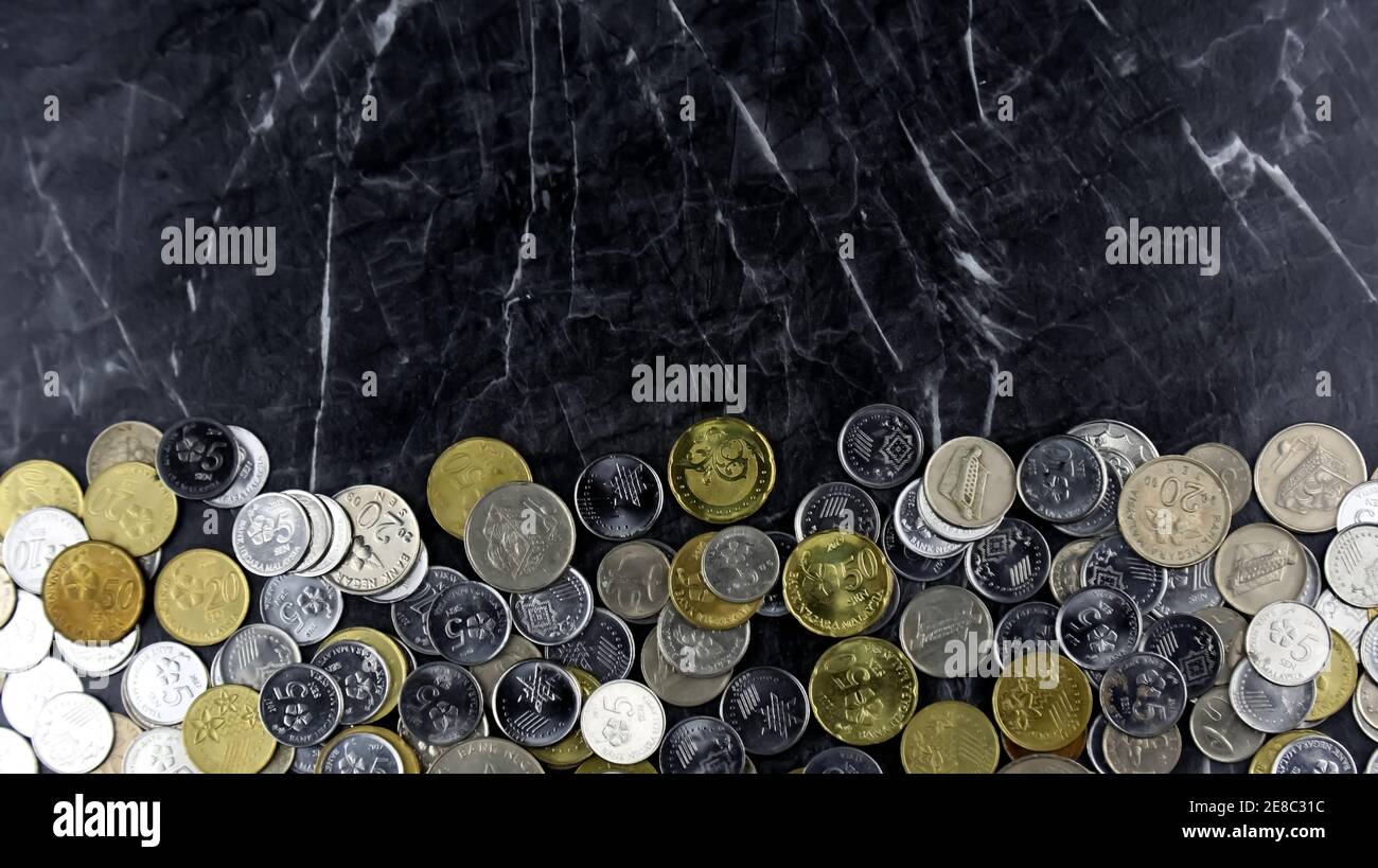 Malaysia coins on a black rough marble surface Stock Photo - Alamy