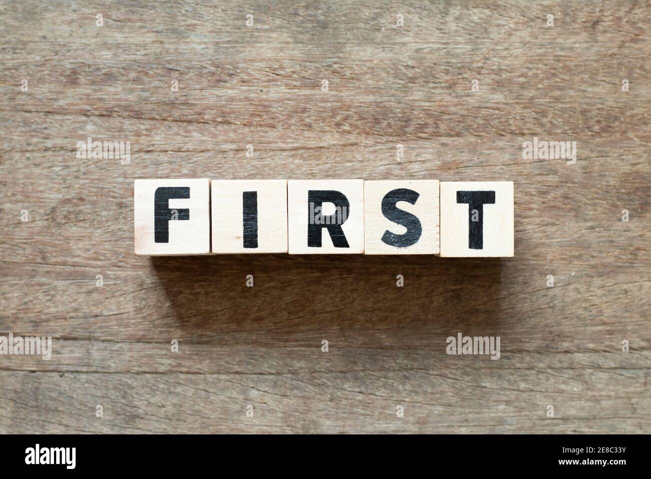 Alphabet letter block in word first on wood background Stock Photo - Alamy
