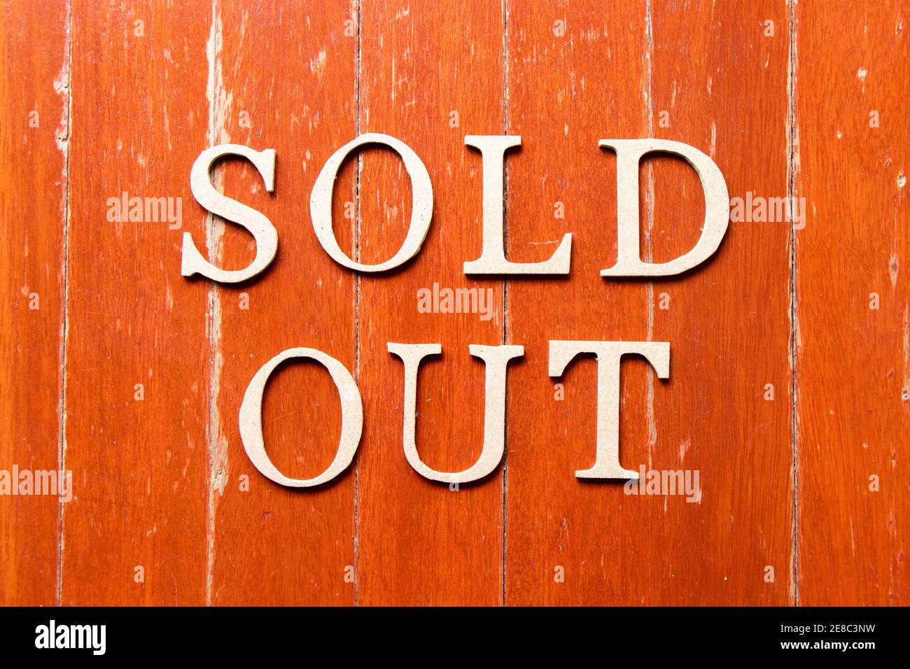 Alphabet letter in word sold out on old red color wood plate background ...