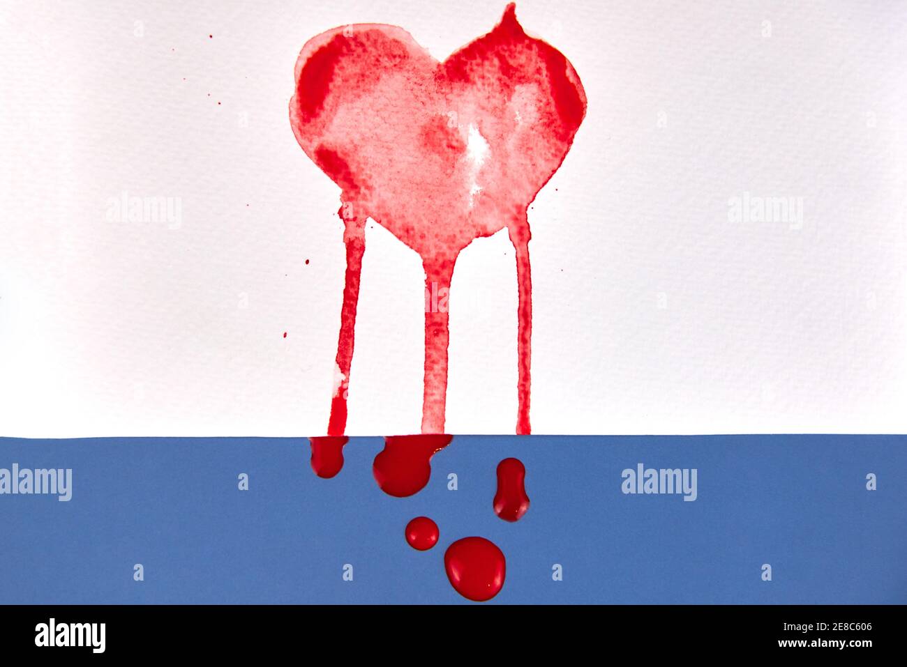 Drawing of a red heart shape with dripping paint in watercolor on white ...