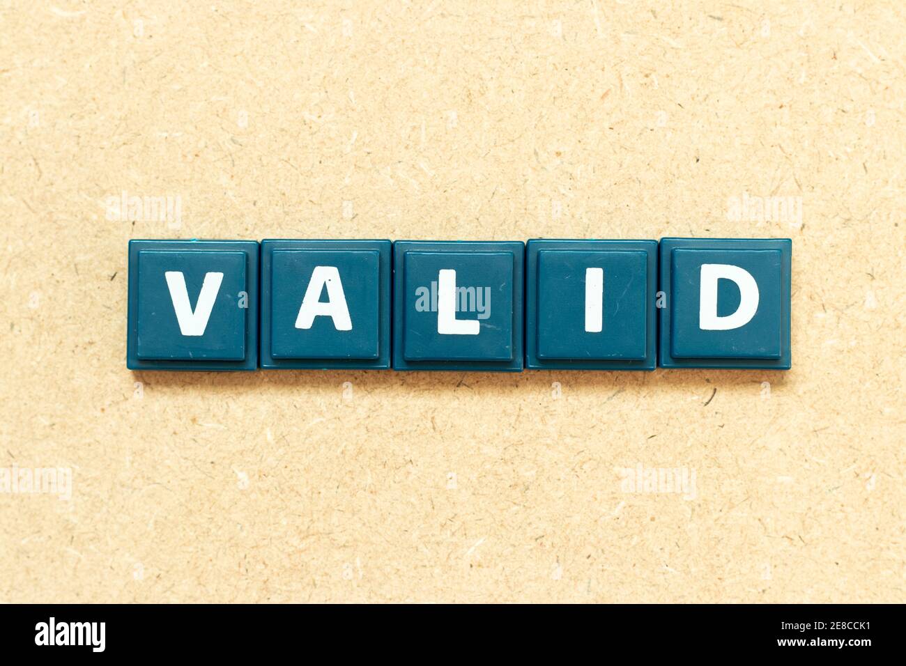Tile alphabet letter in word valid on wood background Stock Photo - Alamy