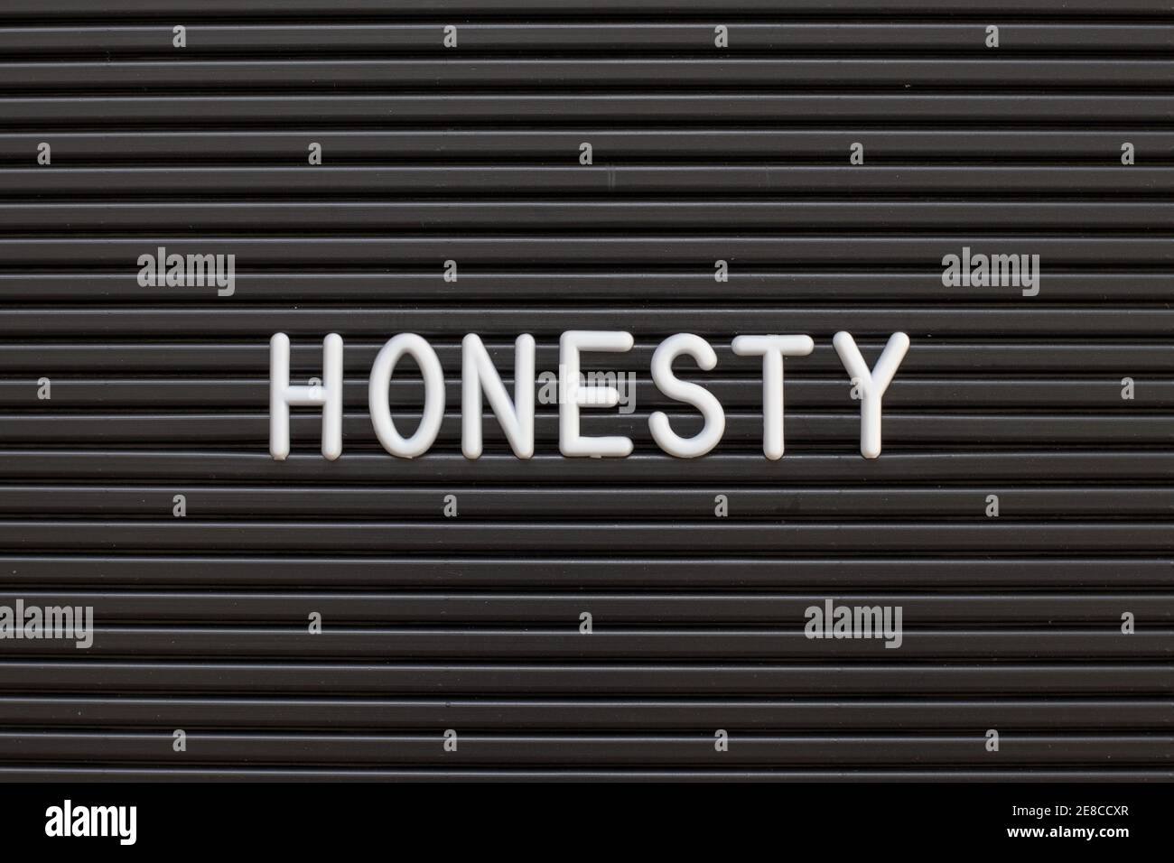 White alphabet in word honesty on black color felt letter board ...