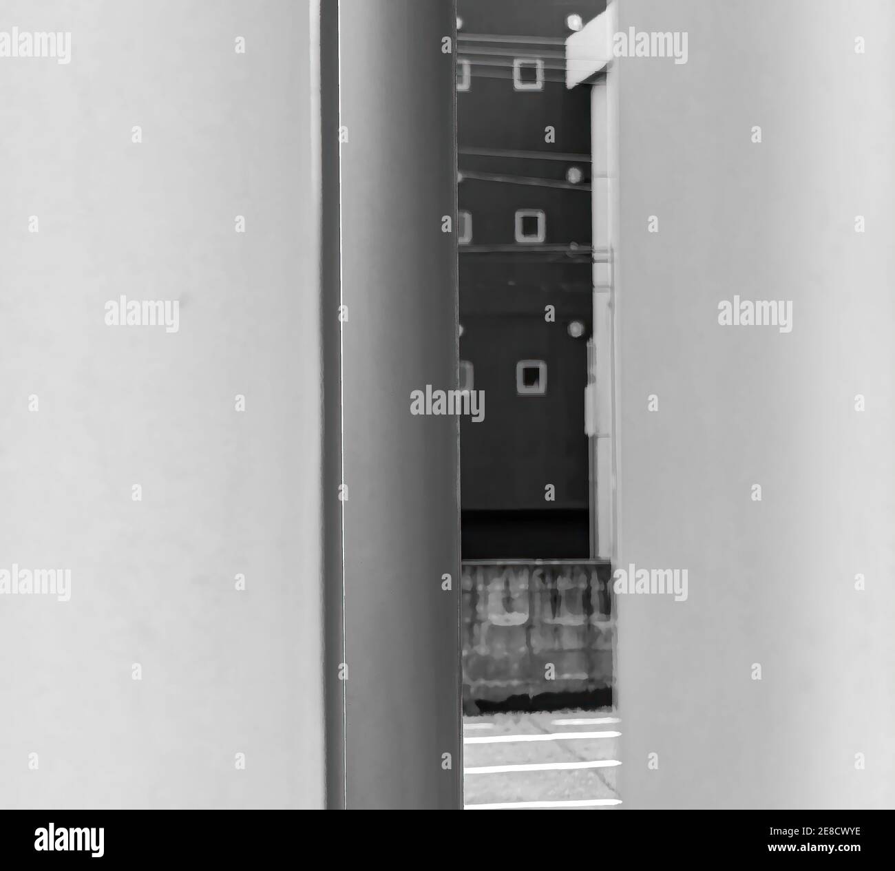 Apartment building seen through a gap between 2 concrete pillars Stock ...