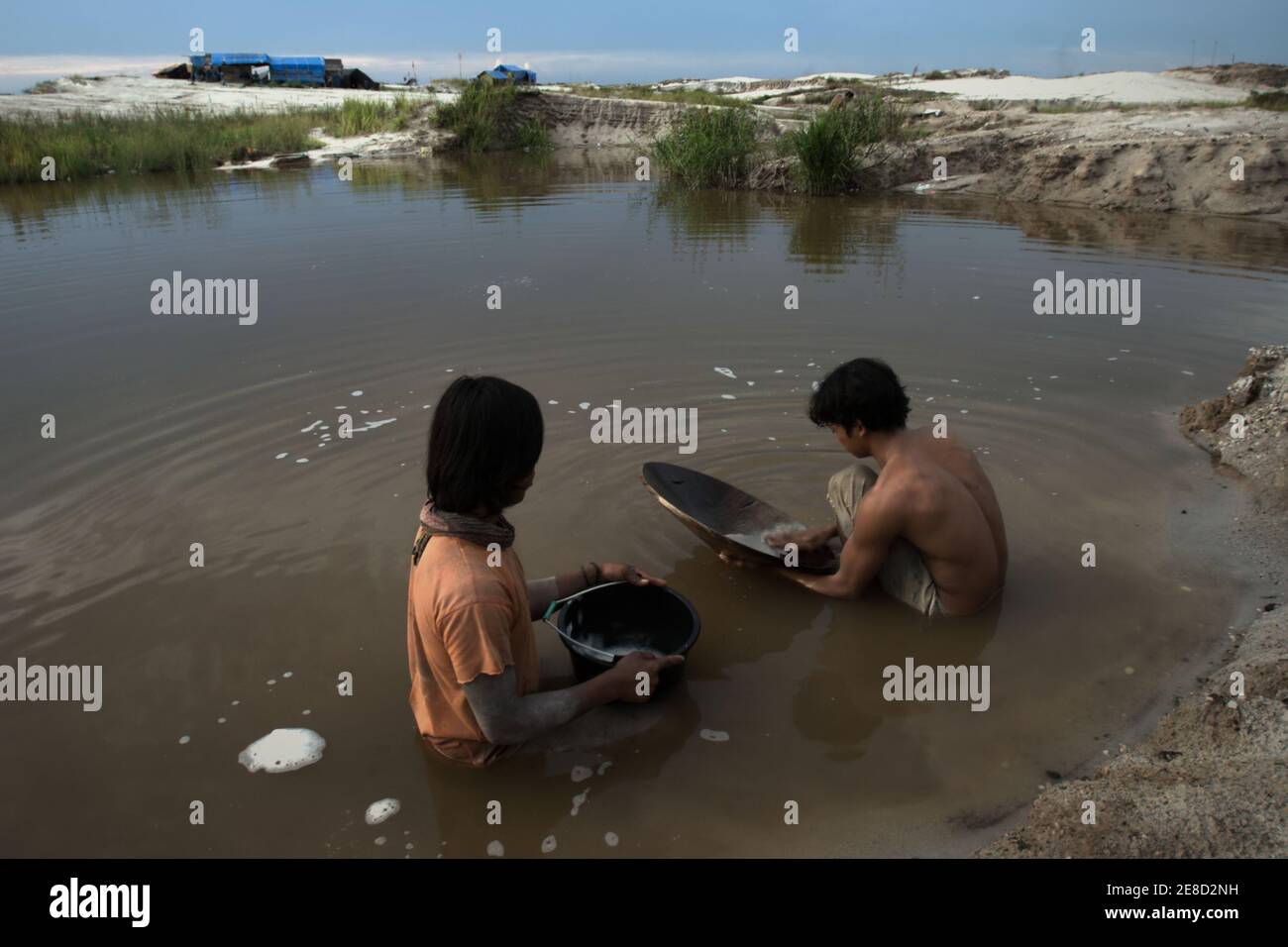 Gold miners panning for gold on a pond in a small-scale gold mining ...