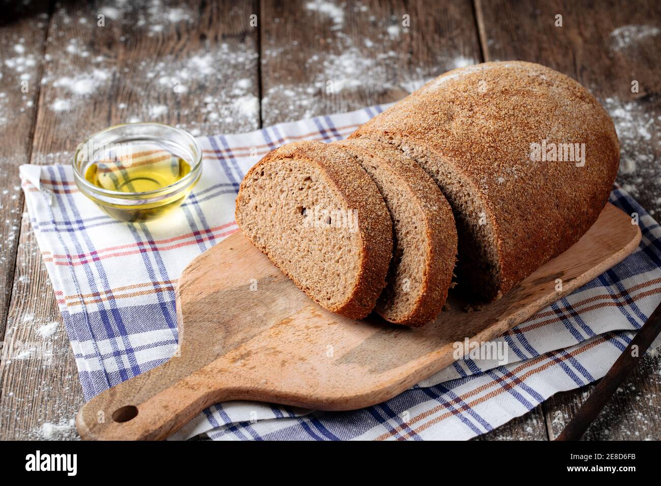 Closeup on sliced gray loaf of bread with oil Stock Photo - Alamy