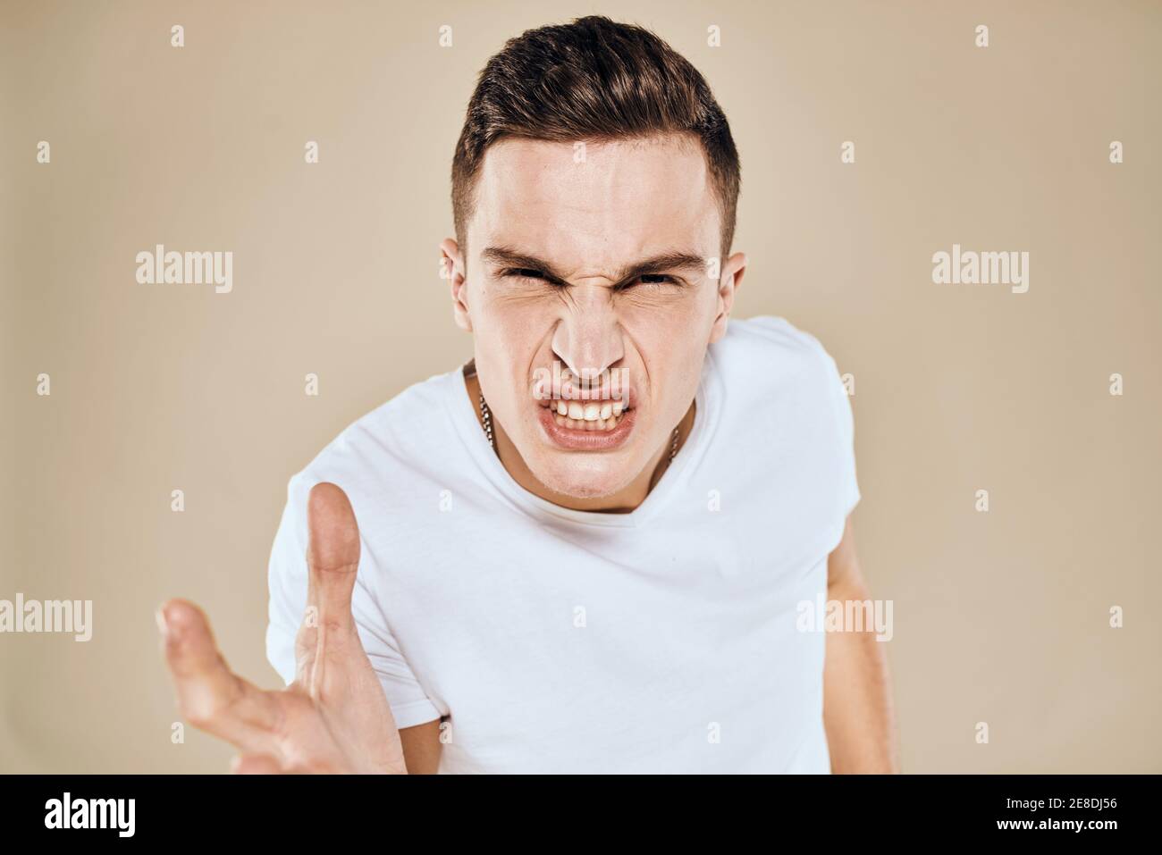 Man with displeased facial expression emotions white t-shirt gestures ...