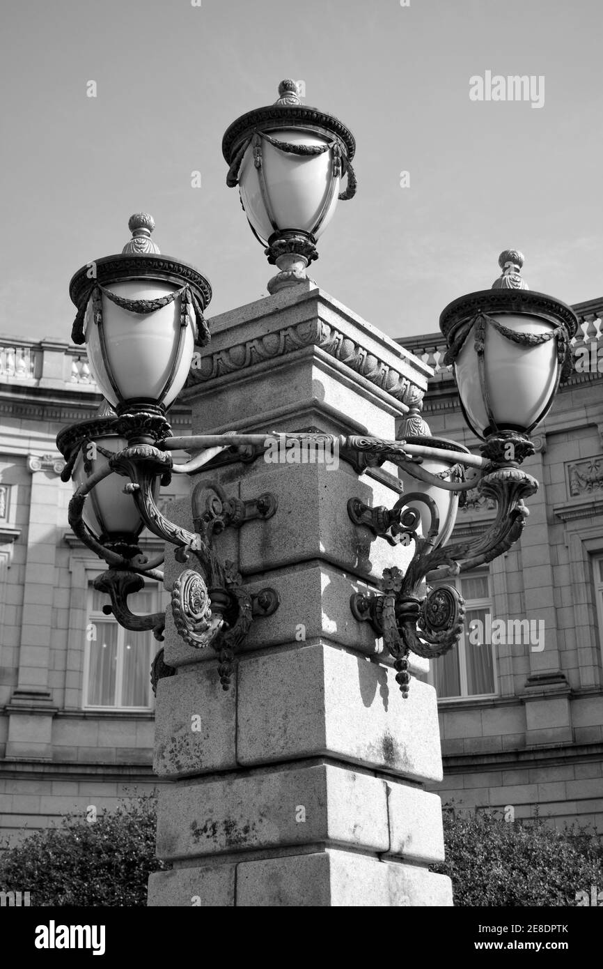 A vertical grayscale shot of lamp post on stone pillar Stock Photo - Alamy