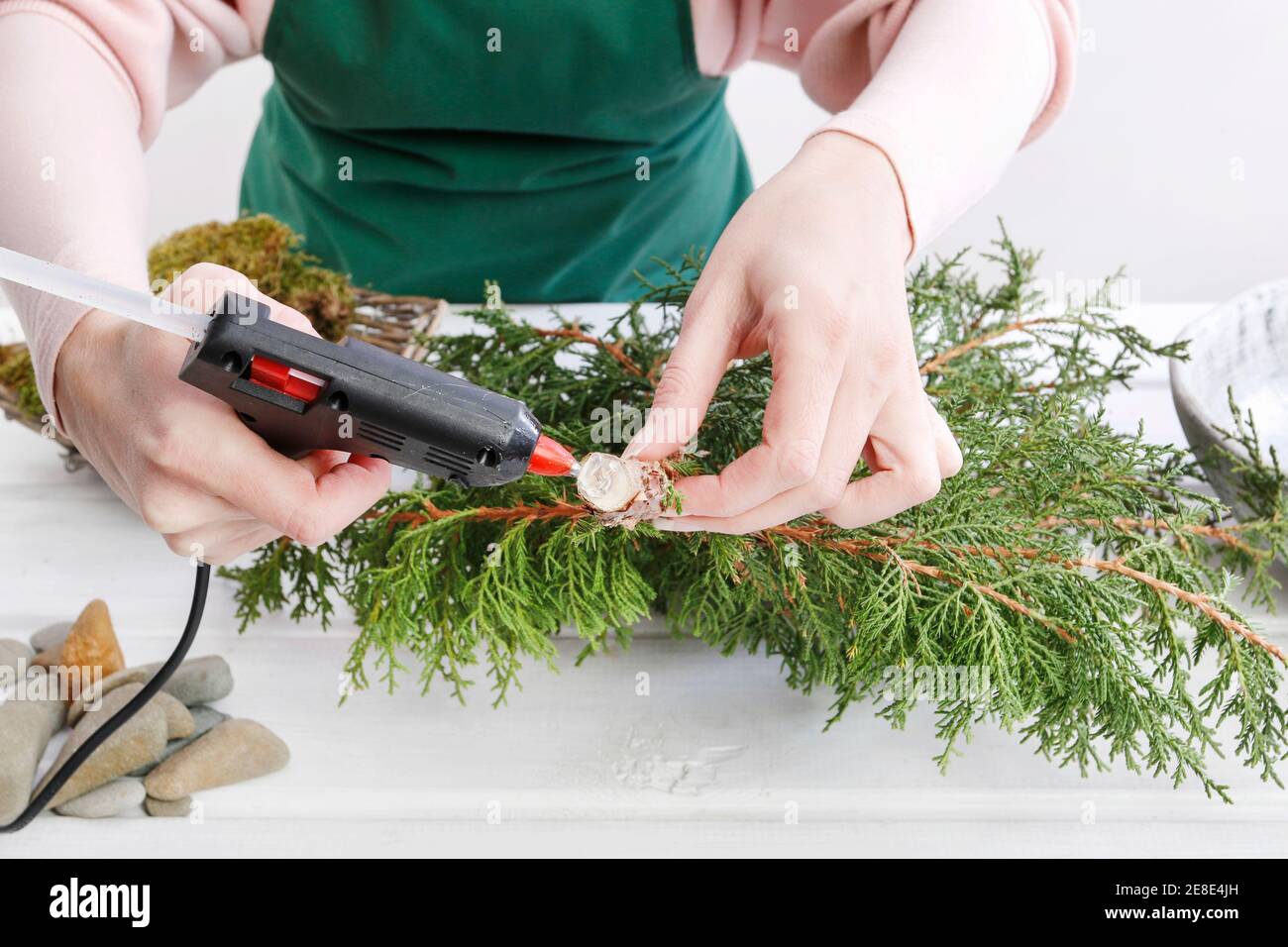 Florist at work: Woman shows how to make small christmas tree with a ...