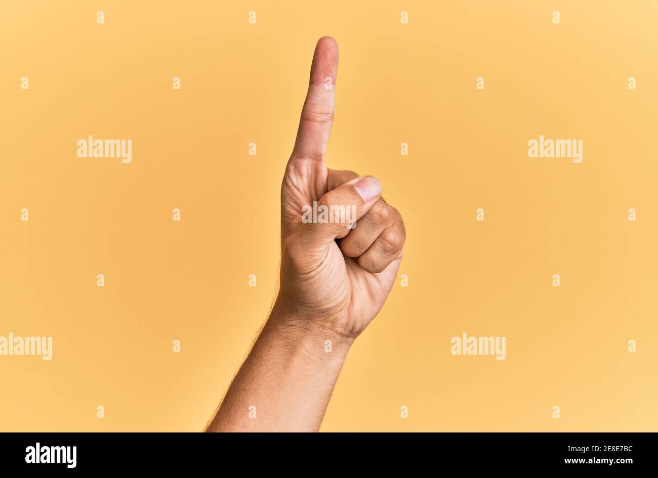 Arm and hand of caucasian man over yellow isolated background counting ...