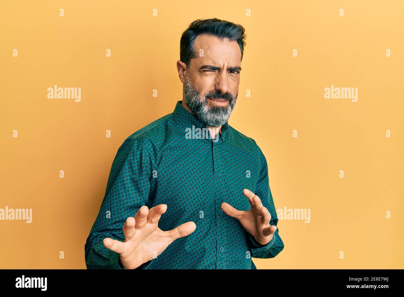Middle age man with beard and grey hair wearing business clothes ...