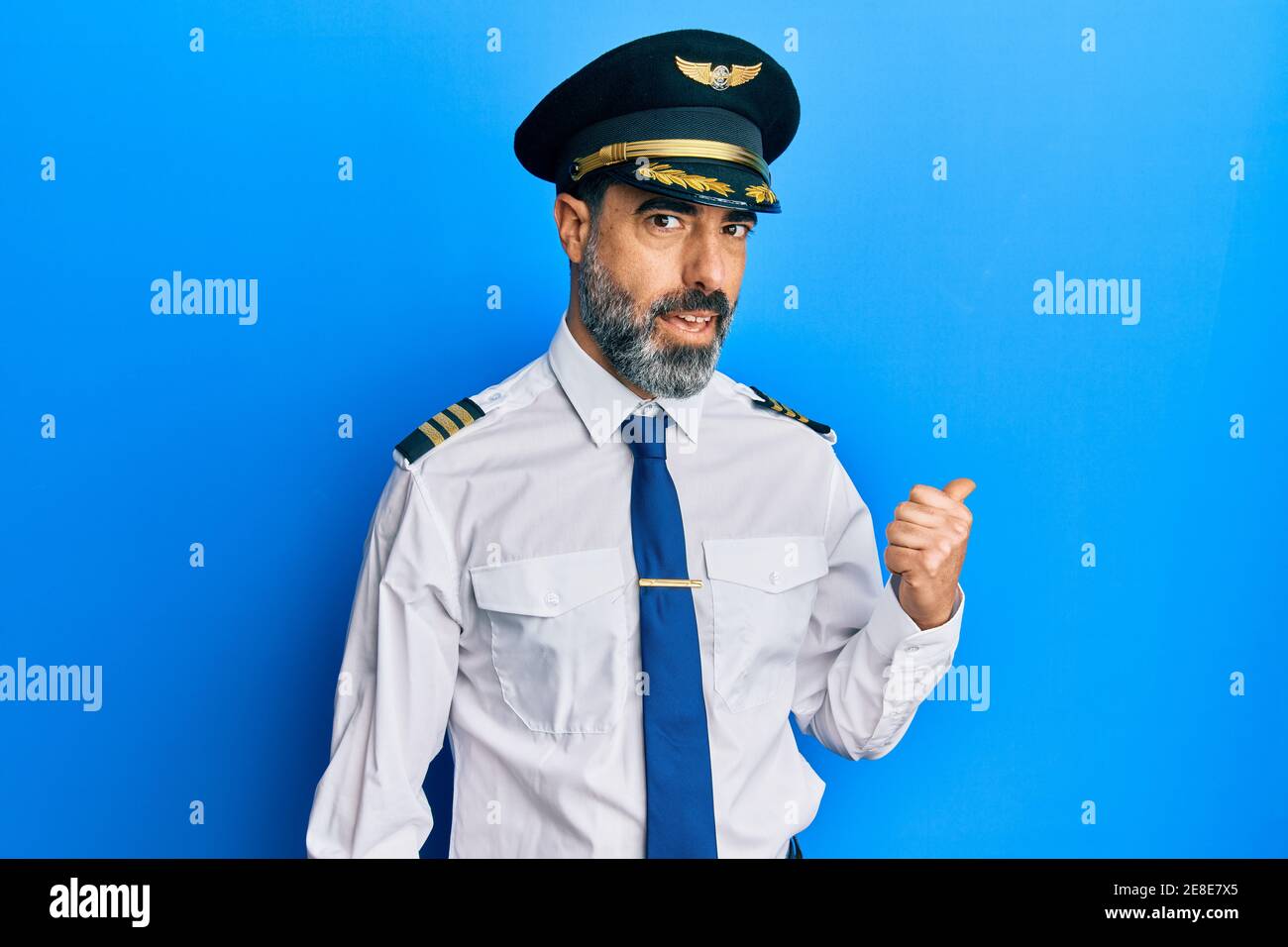 Middle age man with beard and grey hair wearing airplane pilot uniform ...