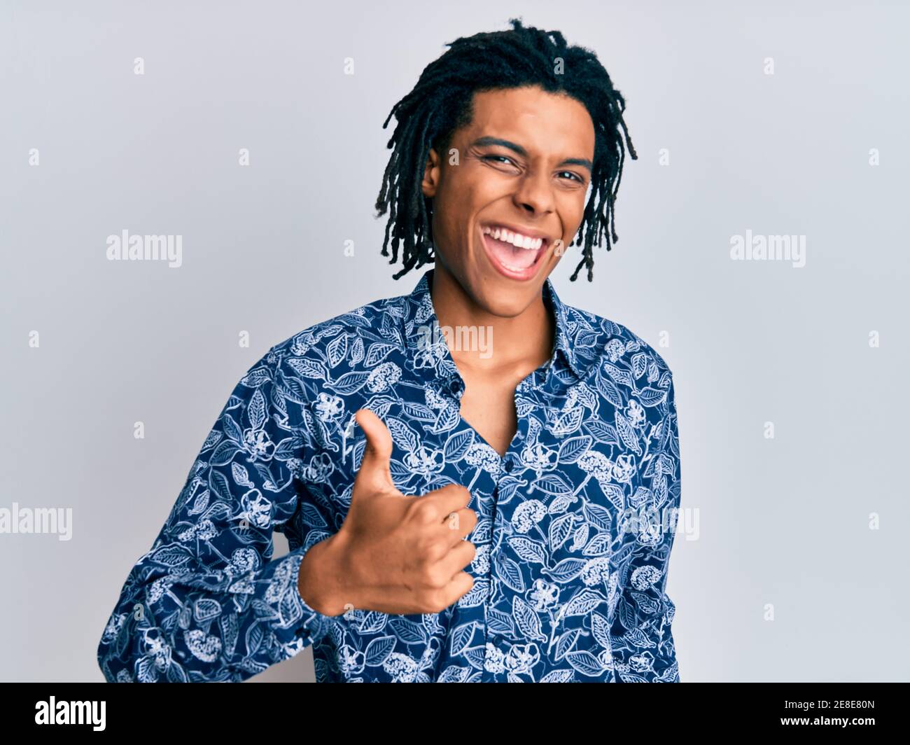 Young african american man wearing 80s style shirt doing happy thumbs ...