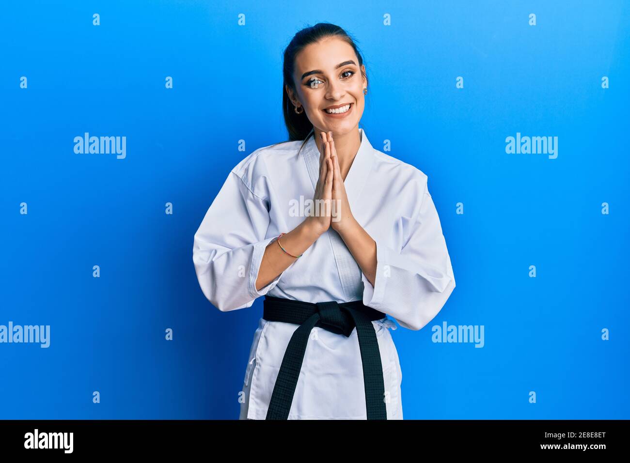 Beautiful brunette young woman wearing karate fighter uniform with ...