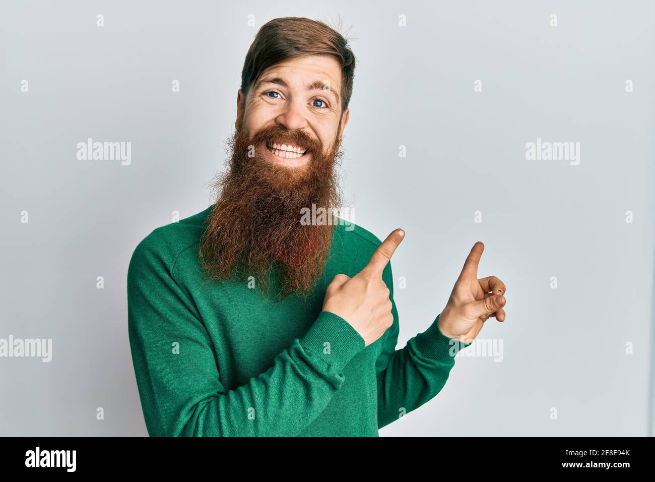 Redhead Man With Long Beard Wearing Casual Clothes Smiling And Looking