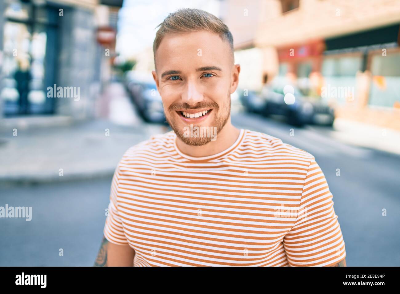 Young irish man smiling happy walking at street of city Stock Photo - Alamy