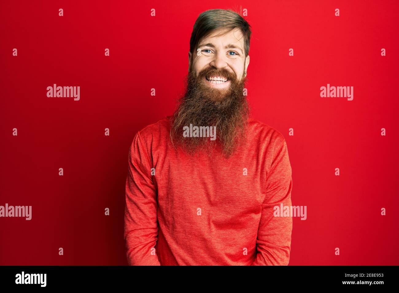 Redhead man with long beard wearing casual clothes with a happy and ...