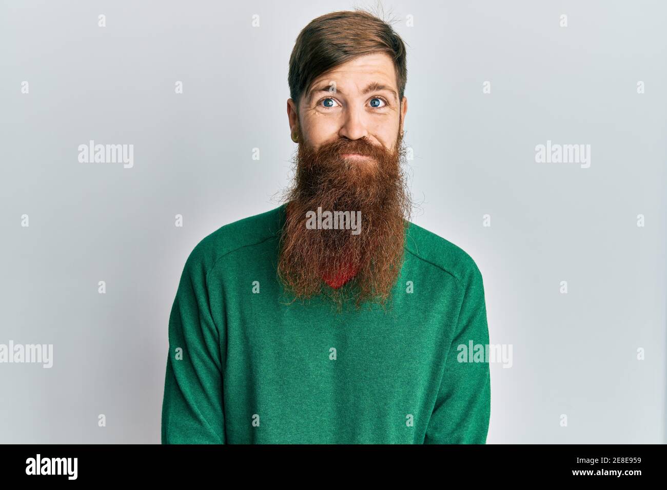 Redhead Man With Long Beard Wearing Casual Clothes Puffing Cheeks With