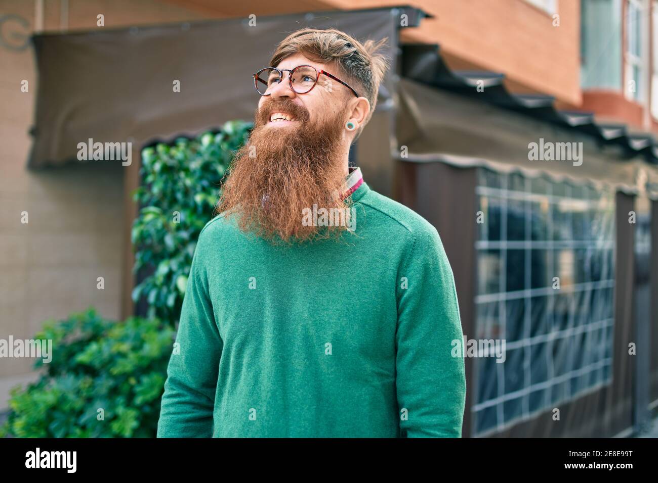 Young irish man with redhead beard smiling happy walking at the city ...