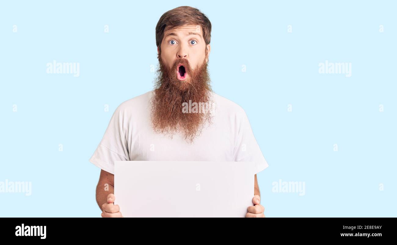 Handsome Young Red Head Man With Long Beard Holding Blank Empty Banner