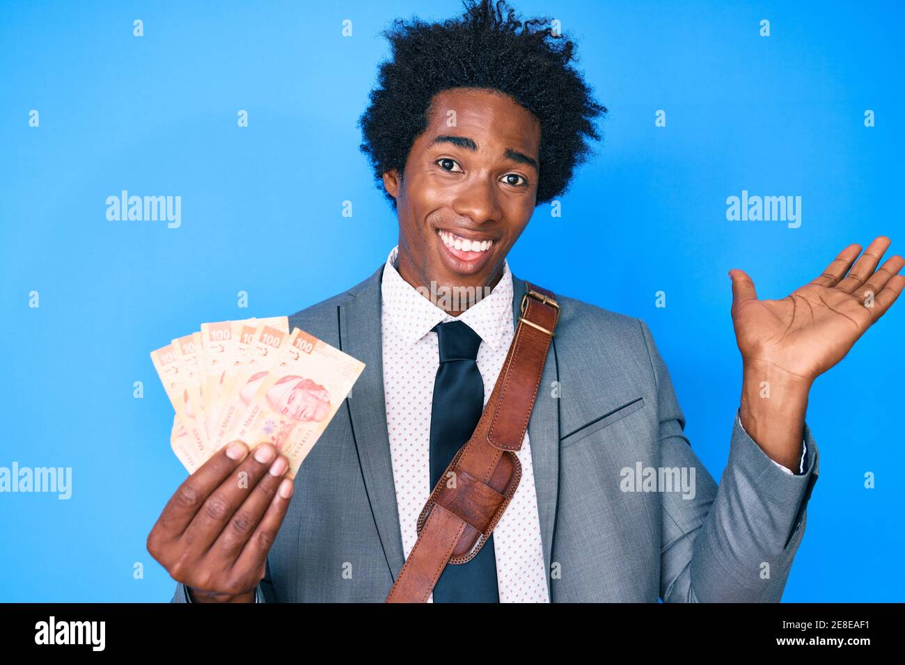 Handsome African American Man With Afro Hair Holding Mexican Pesos
