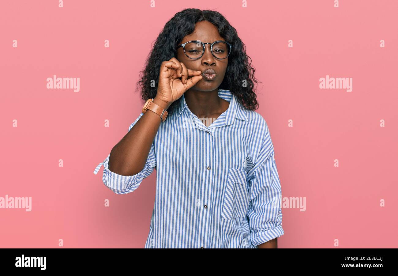 Beautiful African Young Woman Wearing Casual Clothes And Glasses Mouth