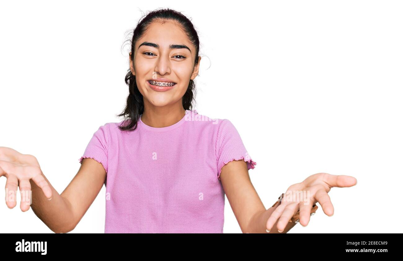 Hispanic teenager girl with dental braces wearing casual clothes ...