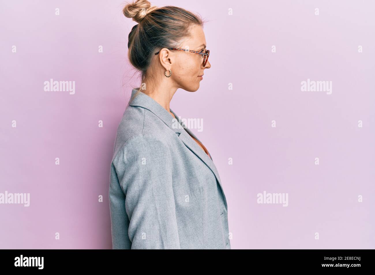 Beautiful caucasian woman wearing business jacket and glasses looking ...
