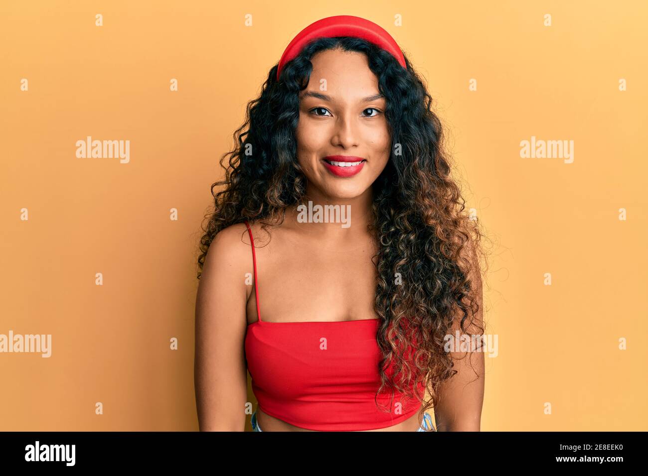 Young latin woman wearing casual clothes with a happy and cool smile on ...