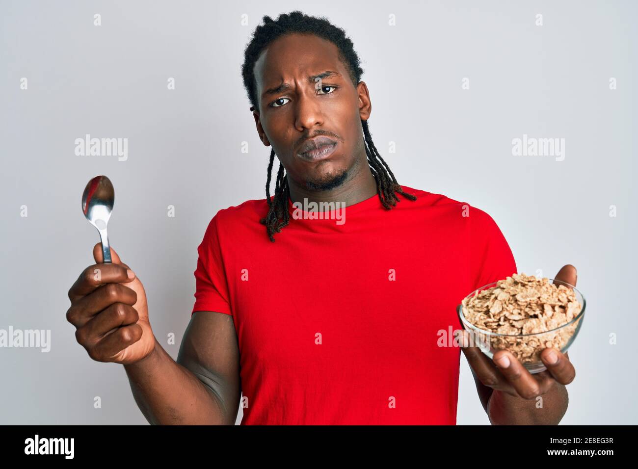 African american man with braids eating healthy whole grain celears ...