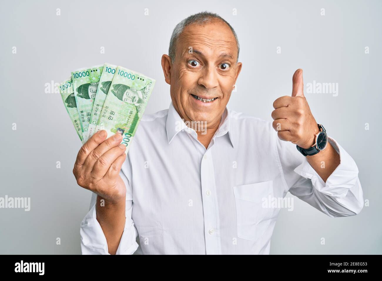 Handsome senior man holding 10000 south korean won banknotes smiling ...
