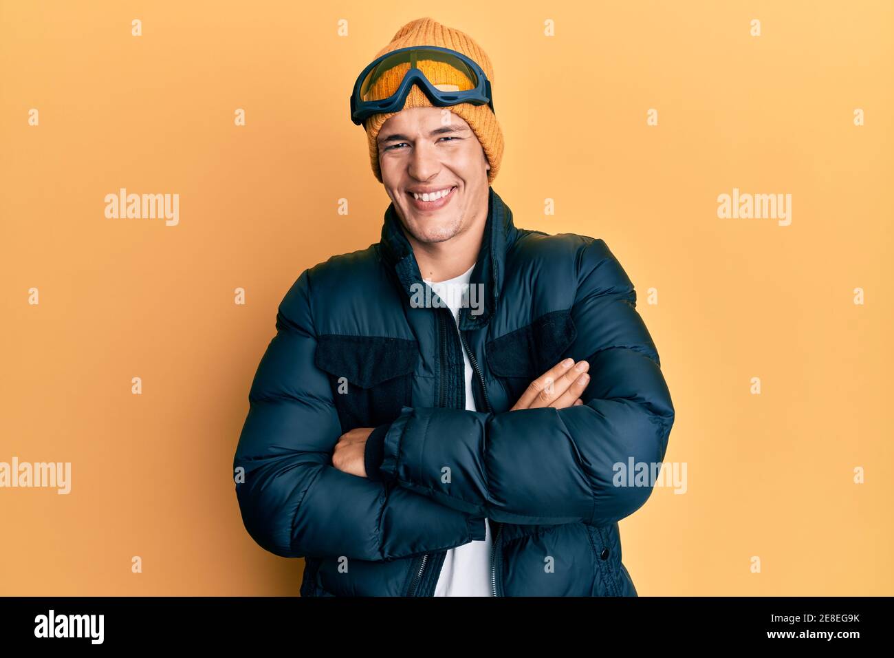 Handsome caucasian man wearing snow wear and sky glasses happy face ...