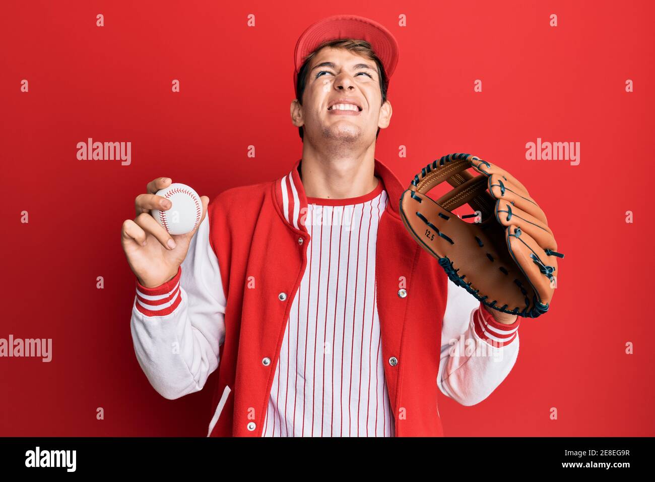 Handsome caucasian man wearing baseball uniform holding golve and ball ...
