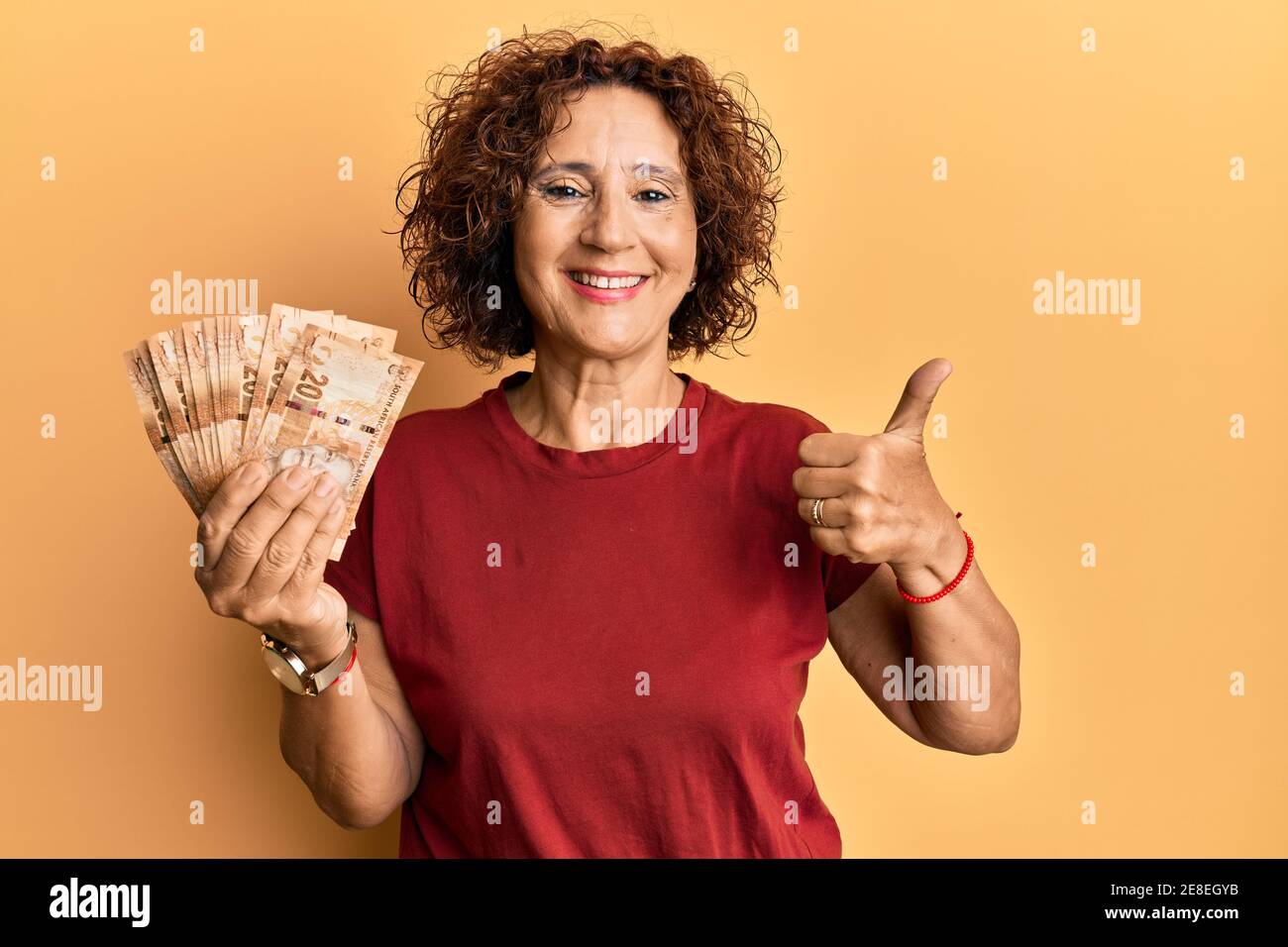 Beautiful middle age mature woman holding south african 20 rand ...