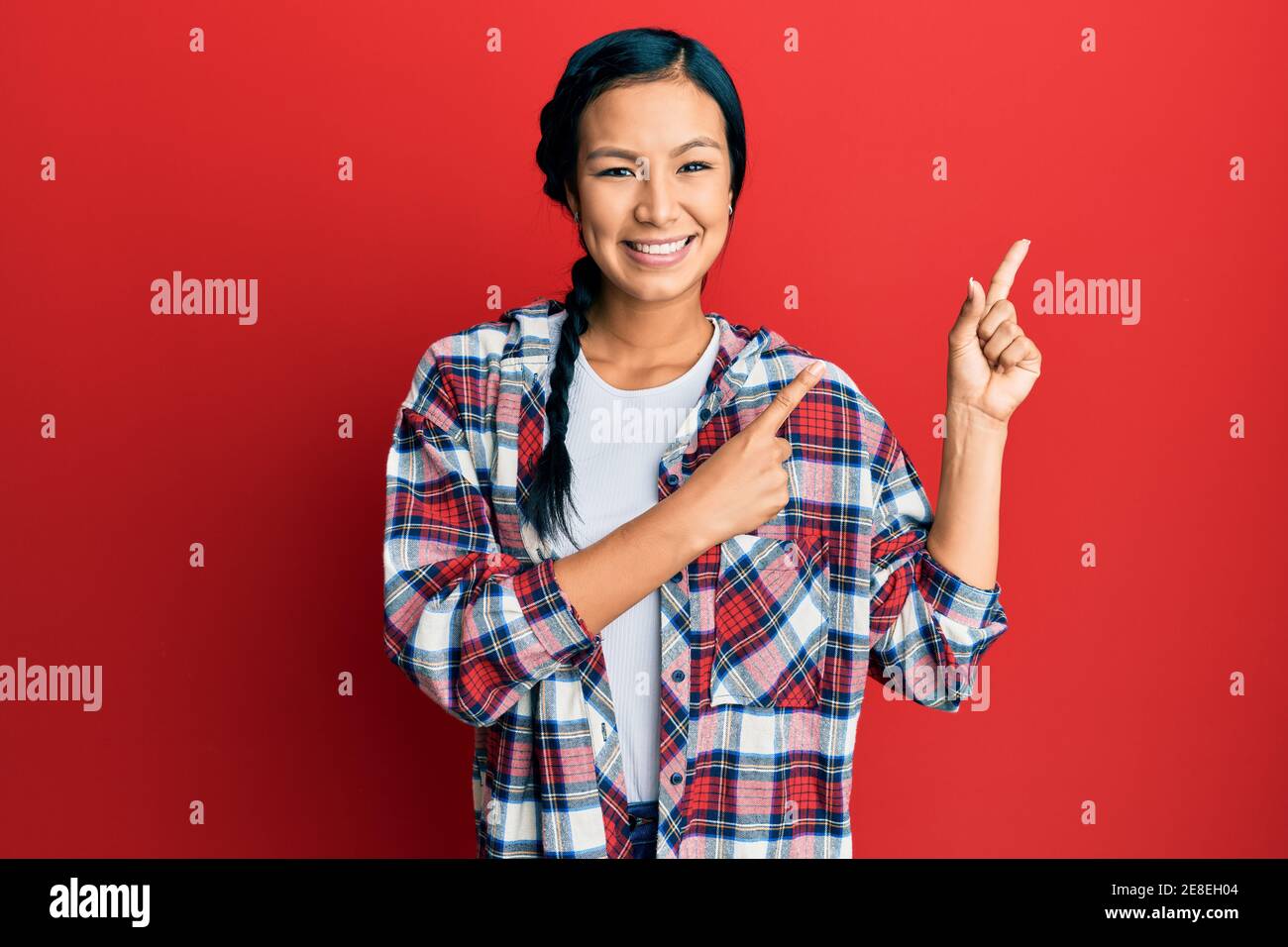 Beautiful Hispanic Woman Wearing Casual Clothes Smiling And Looking At