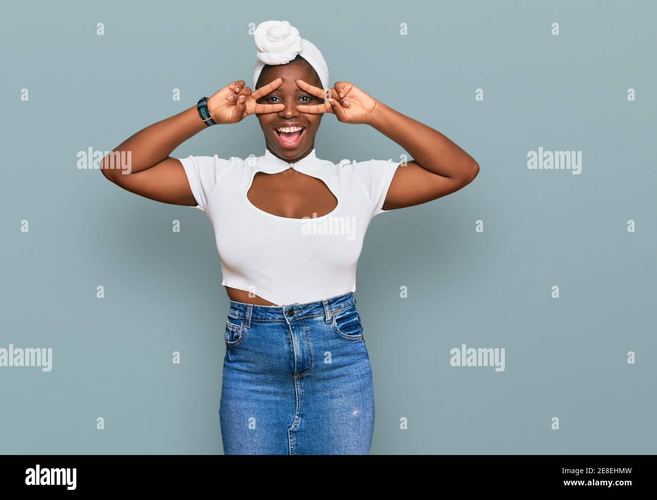 Young african woman with turban wearing hair turban over isolated ...