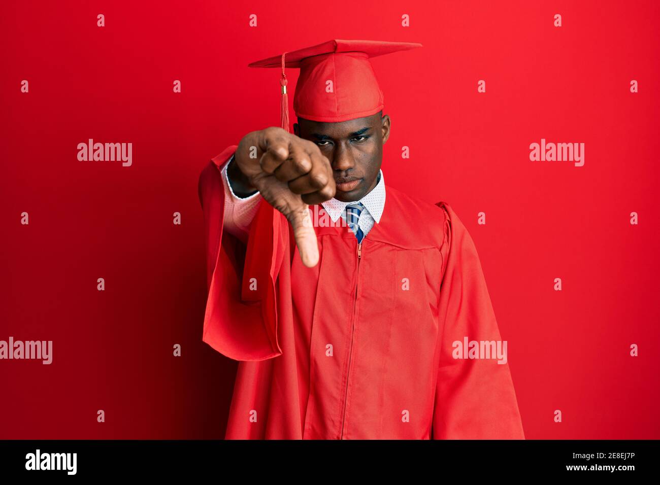Young african american man wearing graduation cap and ceremony robe ...