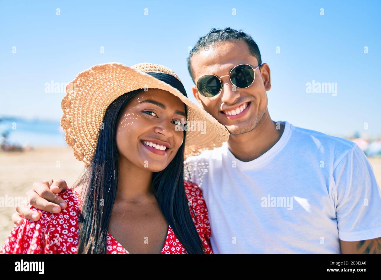 Young latin couple smiling happy and hugging at the beach Stock Photo ...