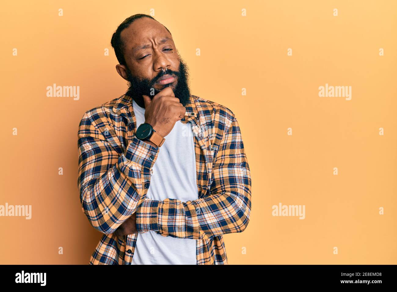 Young african american man wearing casual clothes thinking concentrated ...