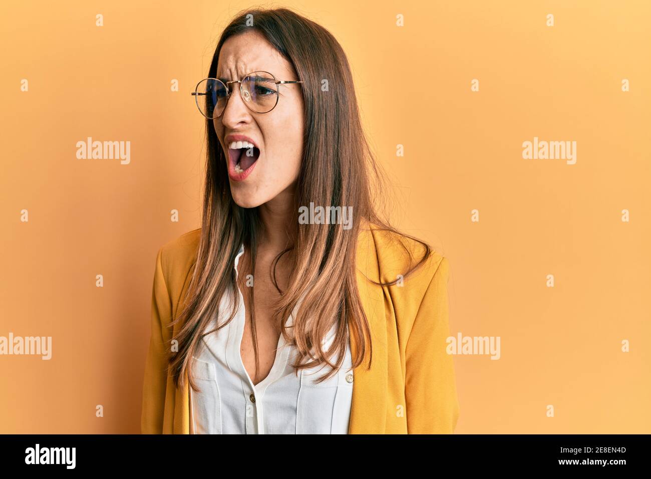 Young beautiful woman wearing business style and glasses angry and mad ...