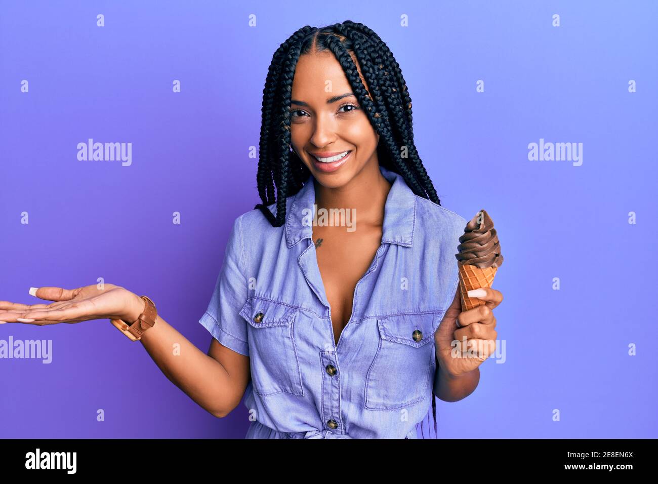 Beautiful hispanic woman eating ice cream celebrating achievement with ...