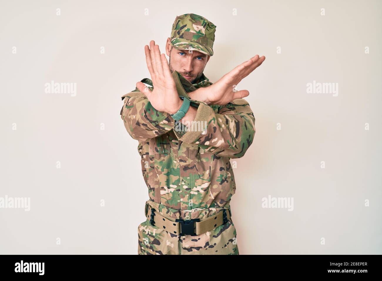 Young caucasian man wearing camouflage army uniform rejection ...