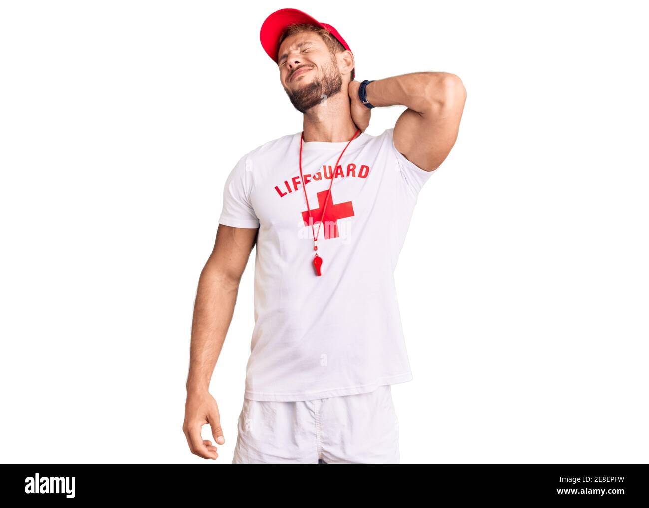 Young caucasian man wearing lifeguard t shirt holding whistle suffering ...