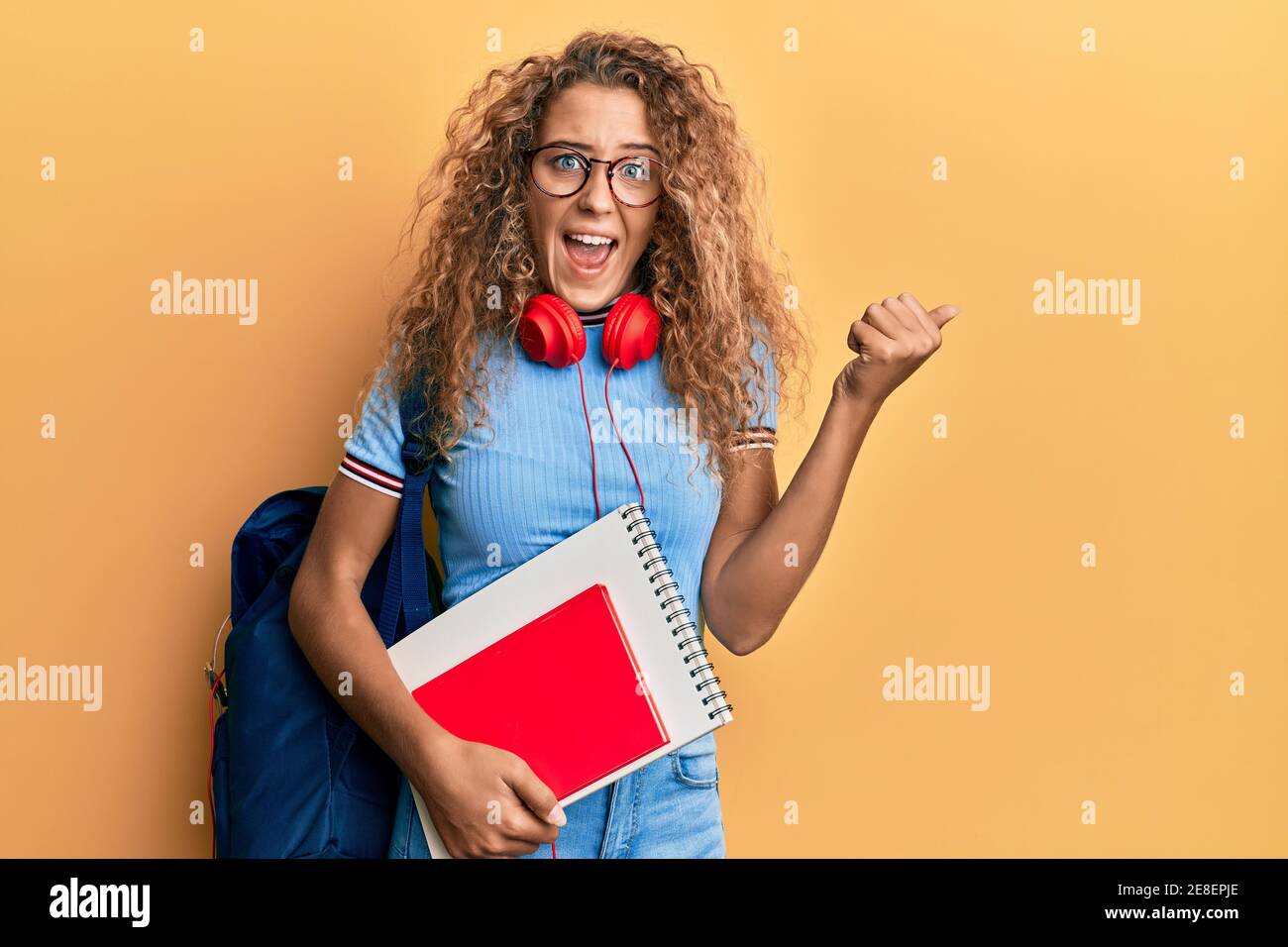 Beautiful caucasian teenager girl wearing student backpack and holding ...
