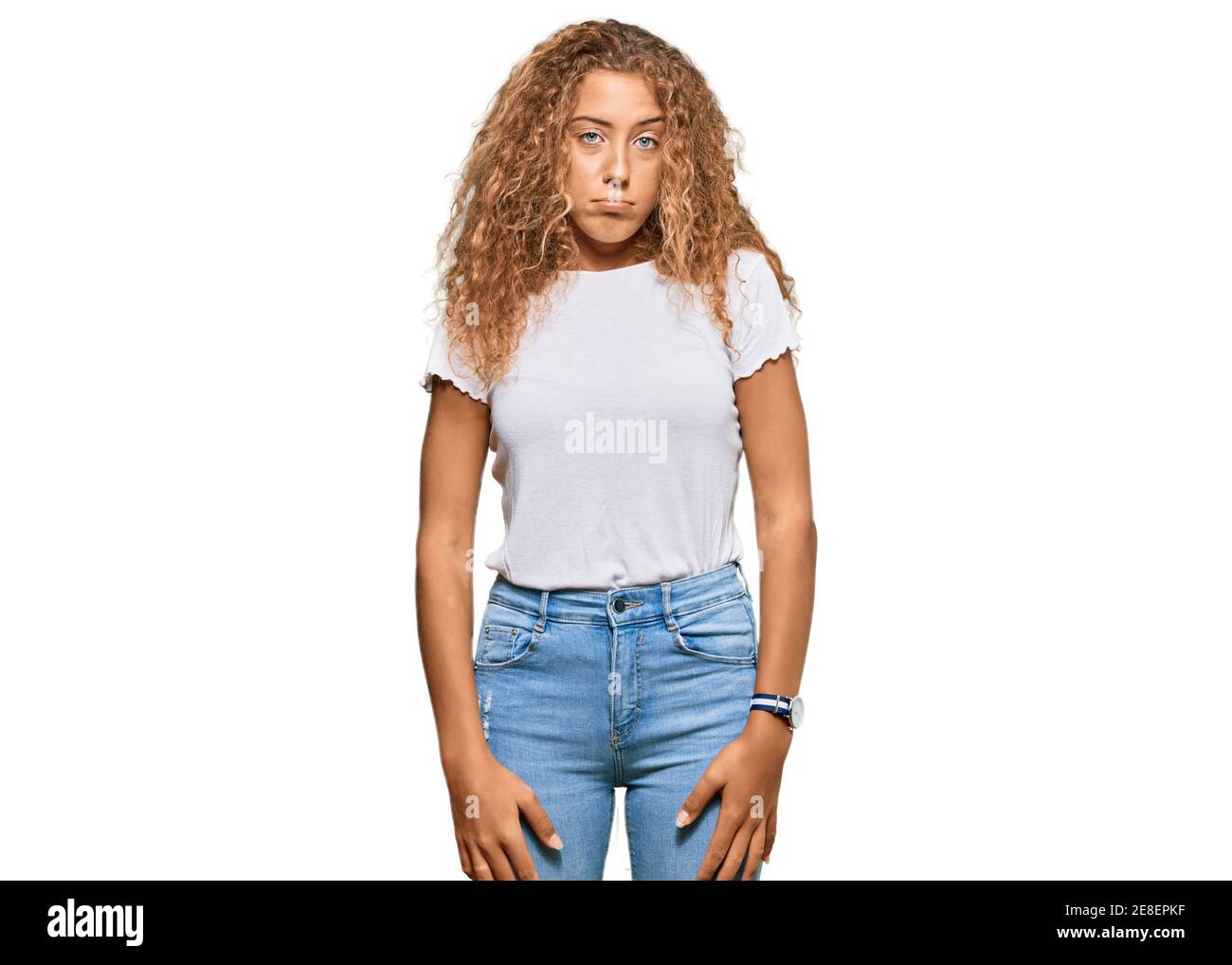 Beautiful caucasian teenager girl wearing casual white tshirt depressed ...