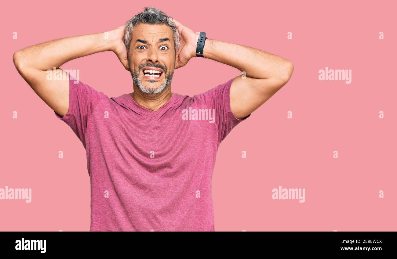 Middle age grey-haired man wearing casual clothes crazy and scared with ...