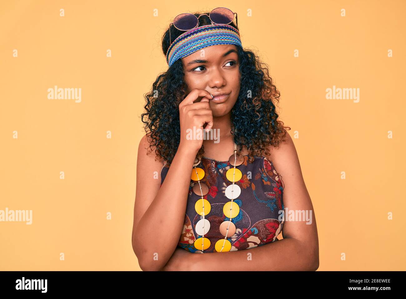 Young african american woman wearing bohemian and hippie style serious ...