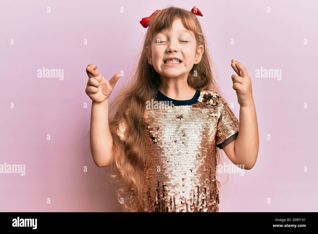 Little caucasian girl kid wearing festive sequins dress gesturing ...