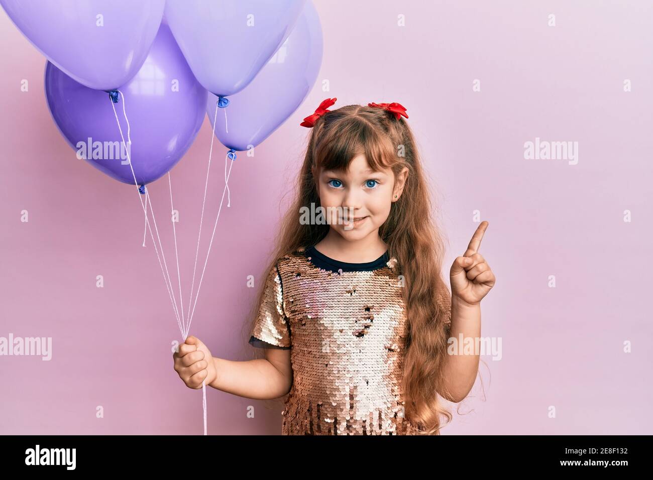 Child pointing pink balloon hi-res stock photography and images - Alamy